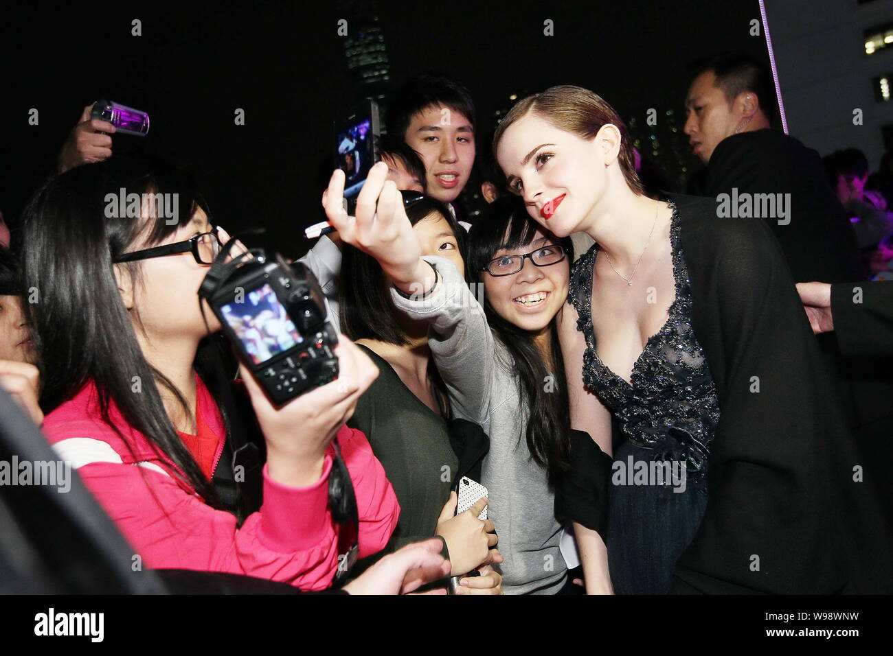 English model and actress Emma Watson poses with fans during a banquet ...