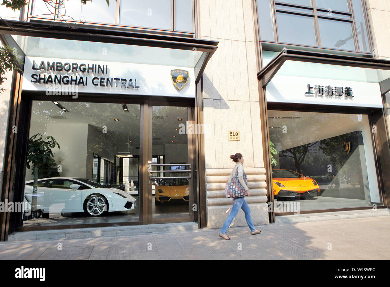 --FILE--A Chinese woman walks past a Lamborghini dealership in Shanghai ...