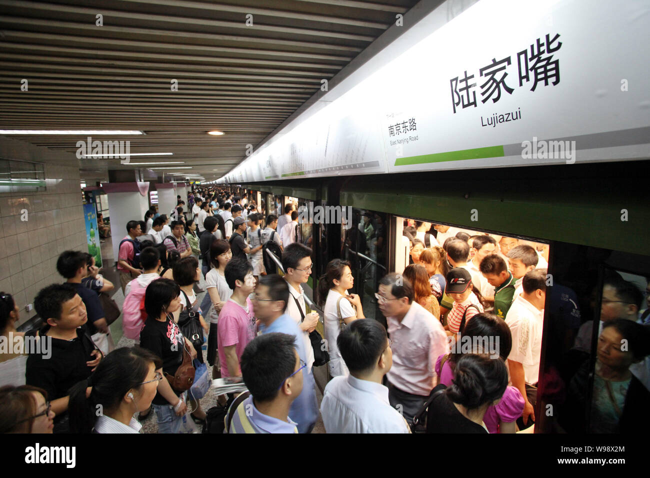 --FILE--Crowds of passengers walk into and out of a Metro train at the ...