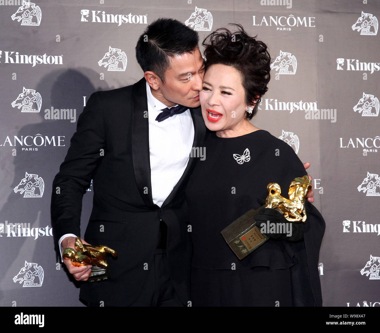 Hong Kong singer and actor Andy Lau kisses Hong Kong actress Deannie ...