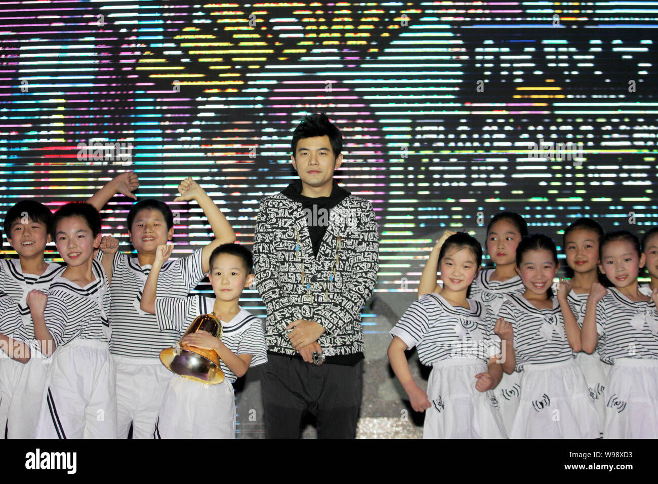 Taiwanese singer and actor Jay Chou poses with young kids at a press ...