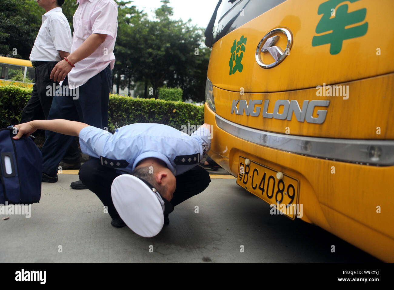 A police officer checks a school bus in Shenzhen city, south Chinas ...