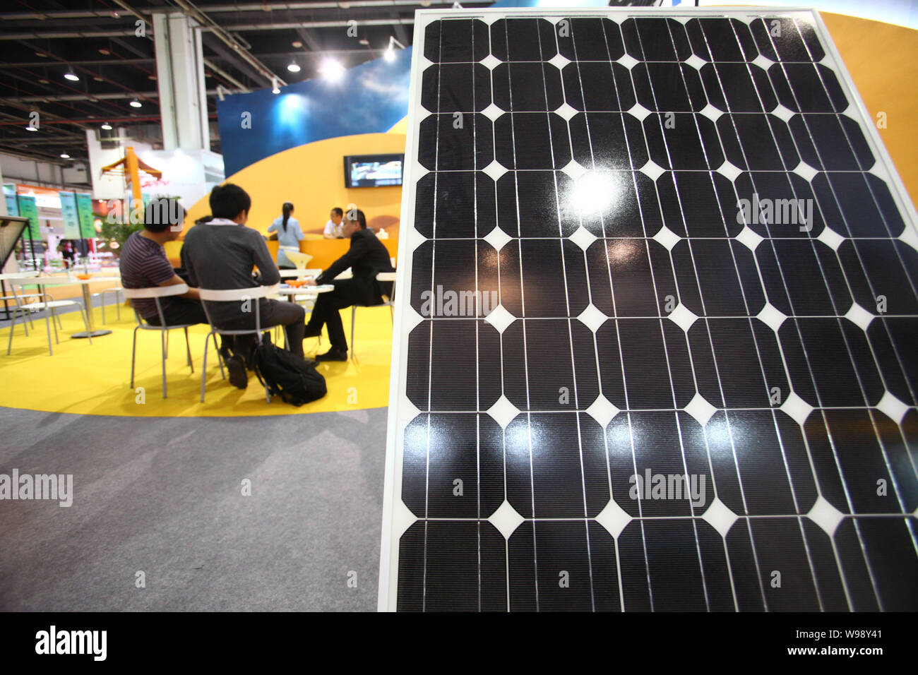 Visitors consult exhibitors about their products at the 6th Asia Solar ...