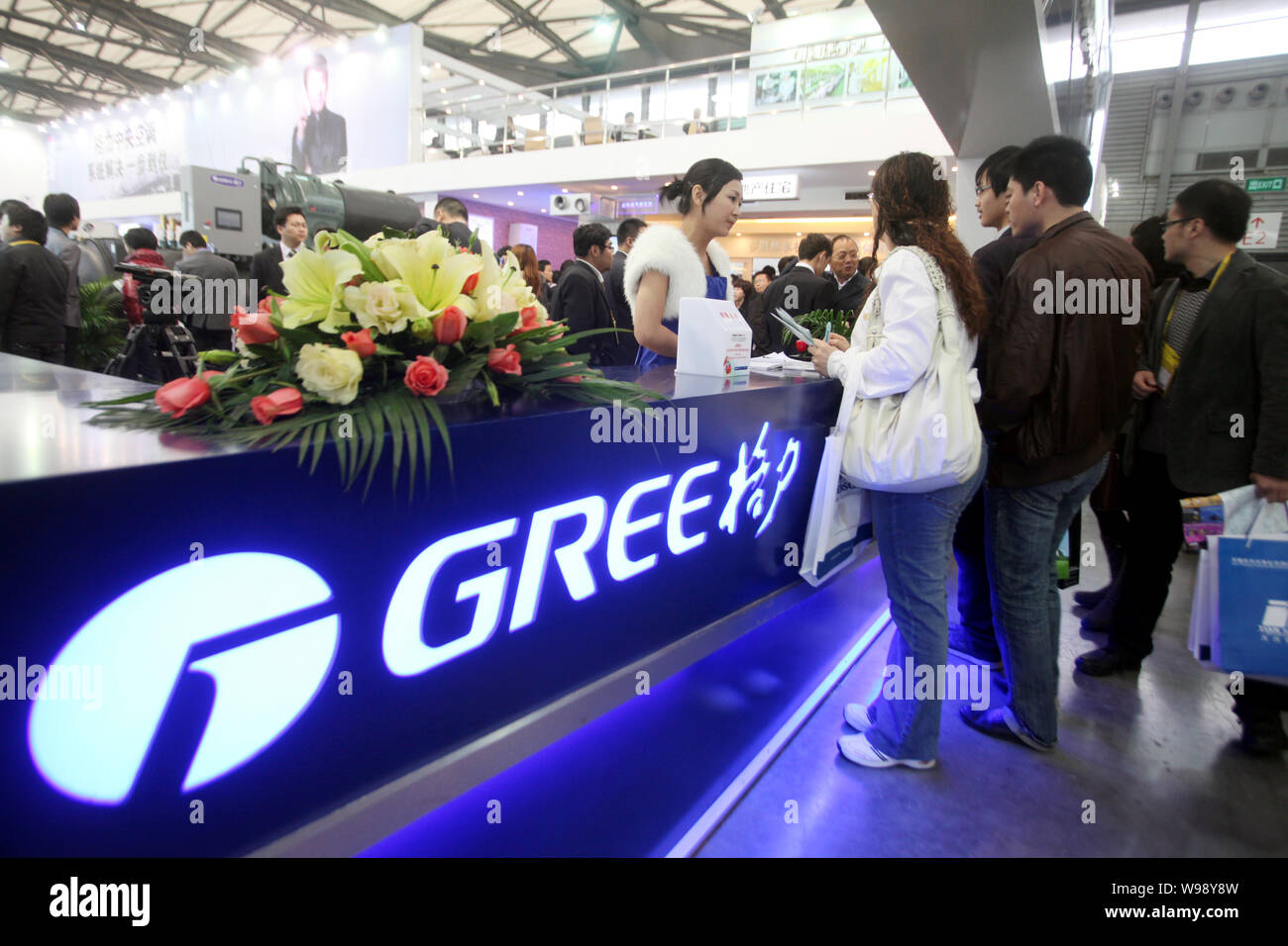 --FILE--Visitors crowd the booth of Gree during an exhibition in ...