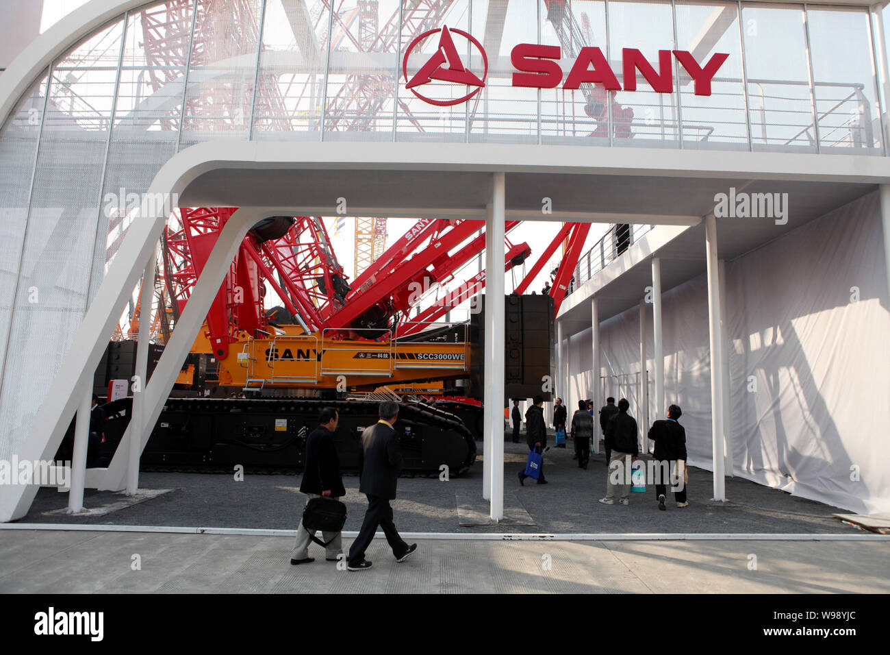 --File-- Visitors look at construction vehicles at the stand of Sany ...