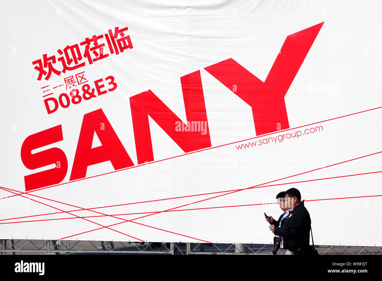 --File-- Visitors walk past an advertisement of Sany Heavy Industry Co ...