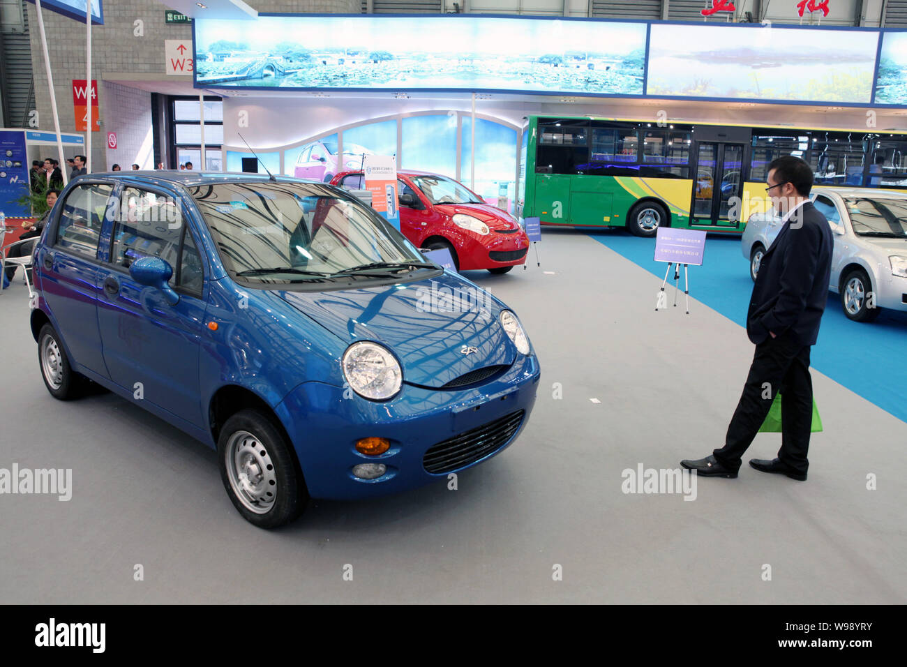 A Chinese man looks at a Chery car during an auto show in Shanghai ...