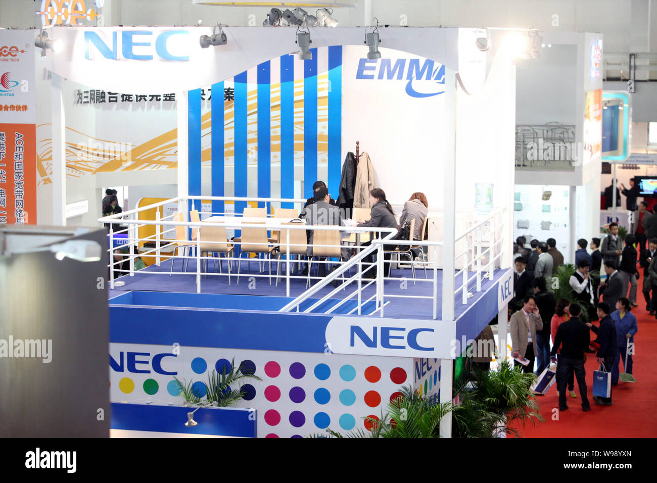 --File-- Visitors are seen at the stand of NEC during an exhibition in ...
