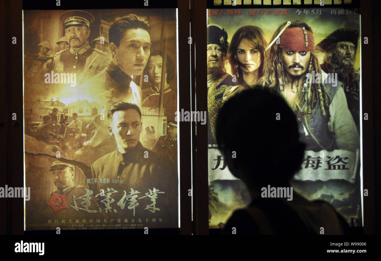 --FILE--A moviegoer looks at the posters of the movies, The Founding of ...