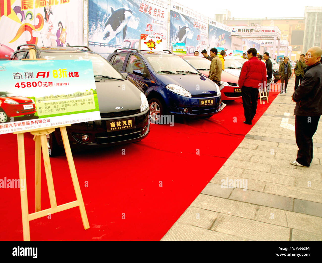 --File-- Chinese car buyers look at Chery cars during an auto show in ...
