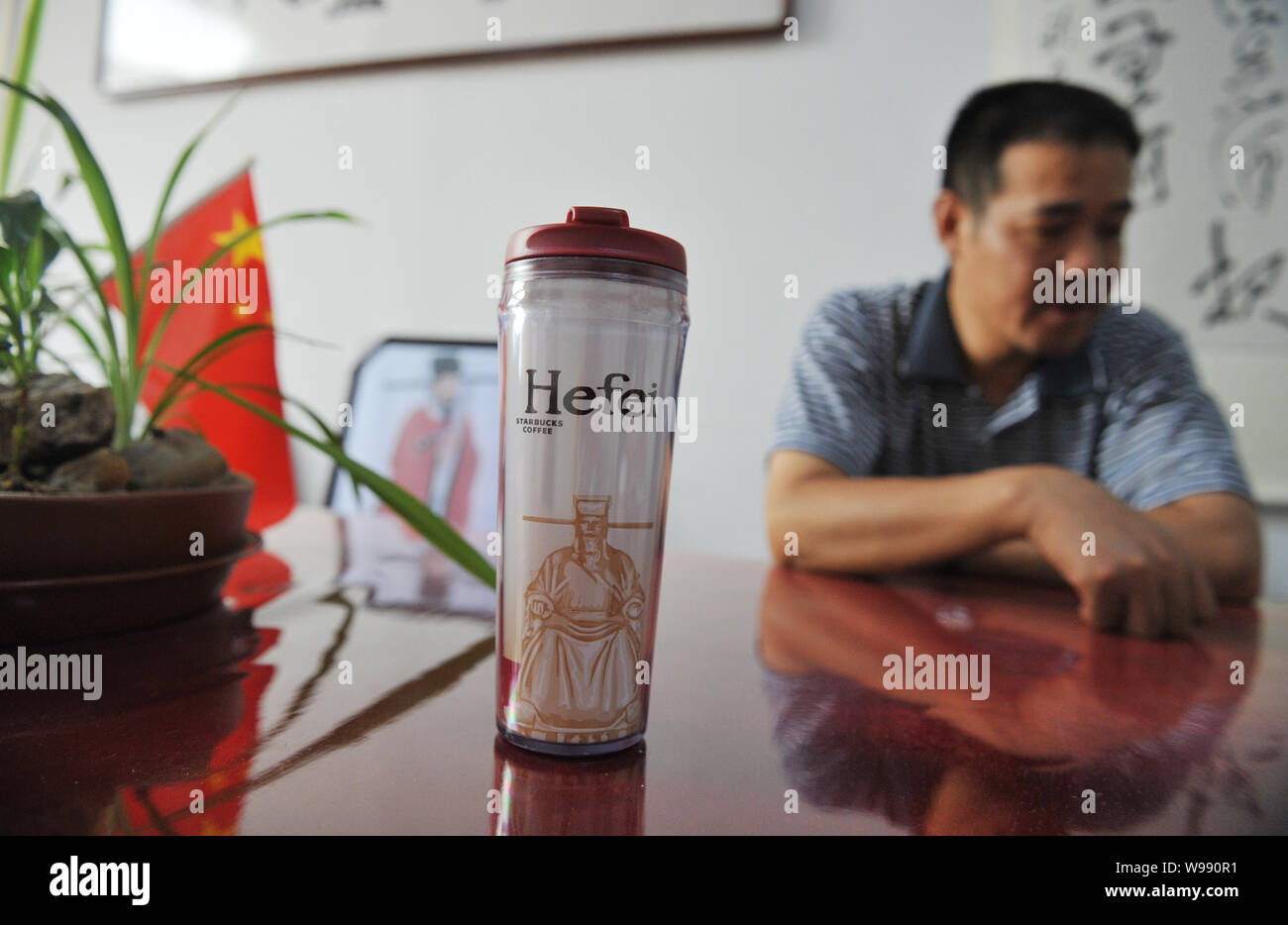 Bao XunAn, a descendant of ancient Chinese judge Bao Zheng, sits next ...