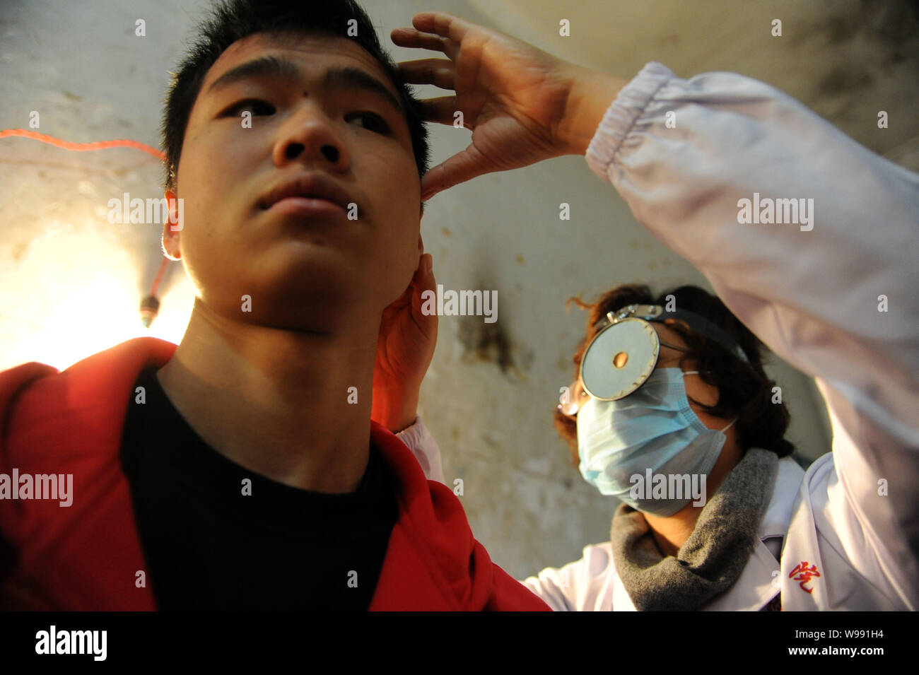 A young man accepts physical examination at a military recruiting ...