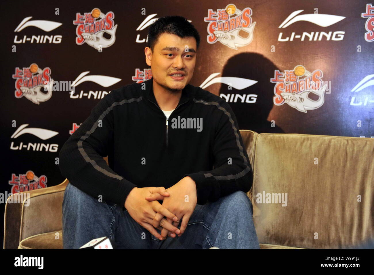 Retired NBA star Yao Ming is interviewed during a signing ceremony ...