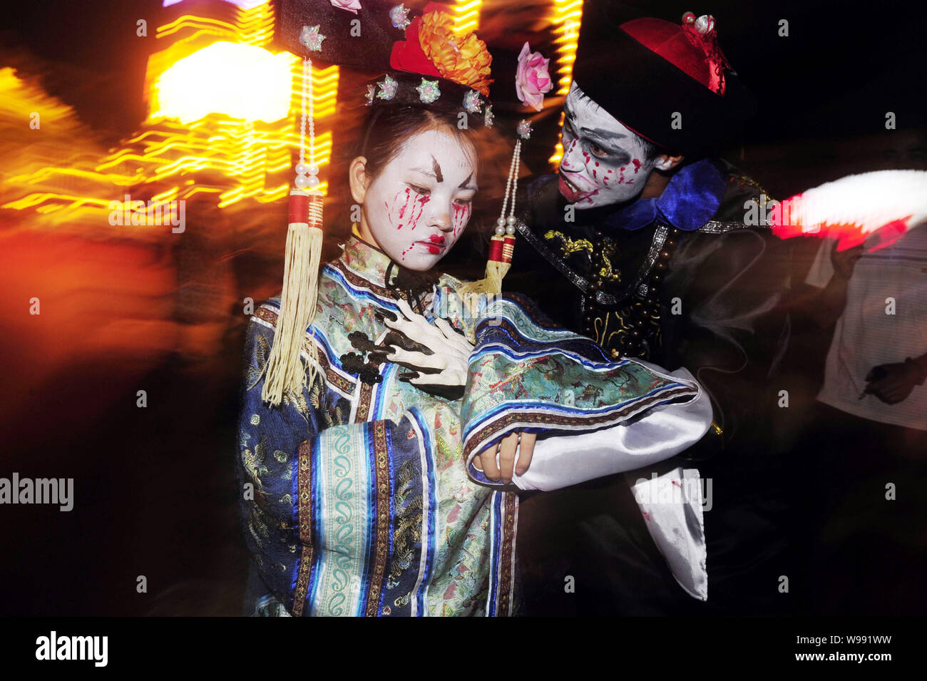 Young people dressed in ghost costumes and with ghost makeup act to ...