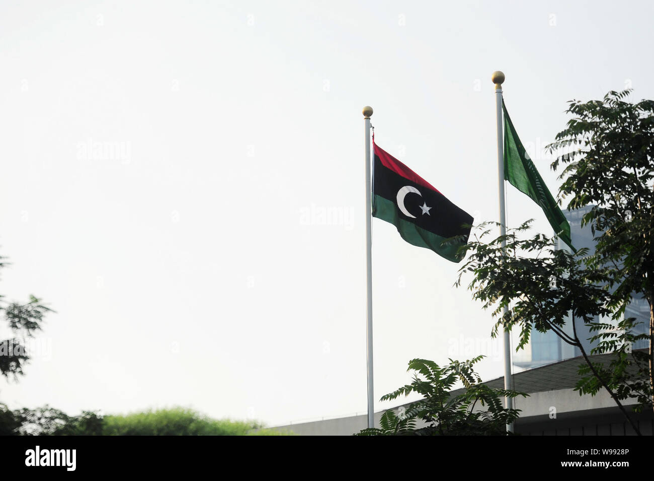 The flag of the Libyan transitional government flutters after the ...