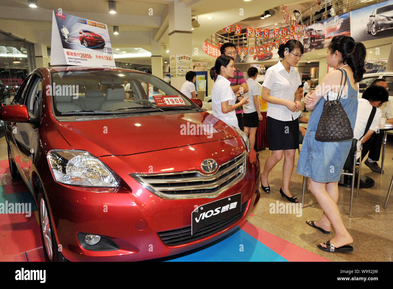 --FILE--Chinese car buyers look at the Toyota Vios at a Toyota ...
