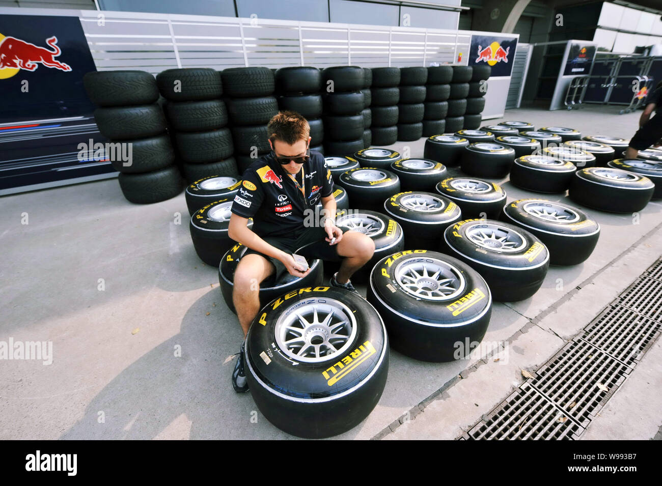 A technician of the Red Bull Racing team tests tires at the pit of the ...