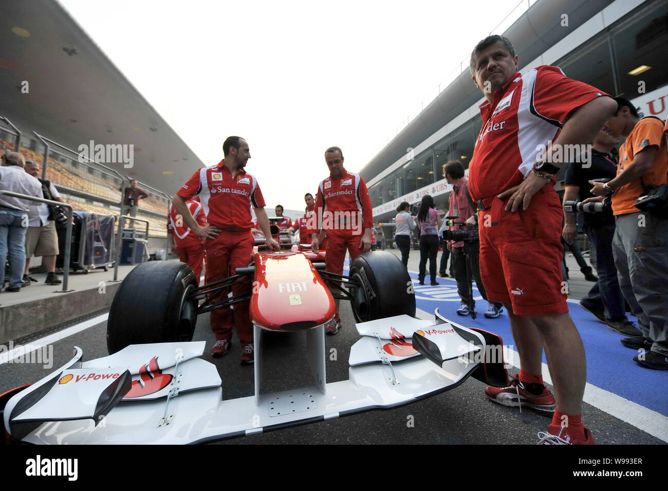 Technicians of the Ferrari team test a racing car at the Shanghai ...
