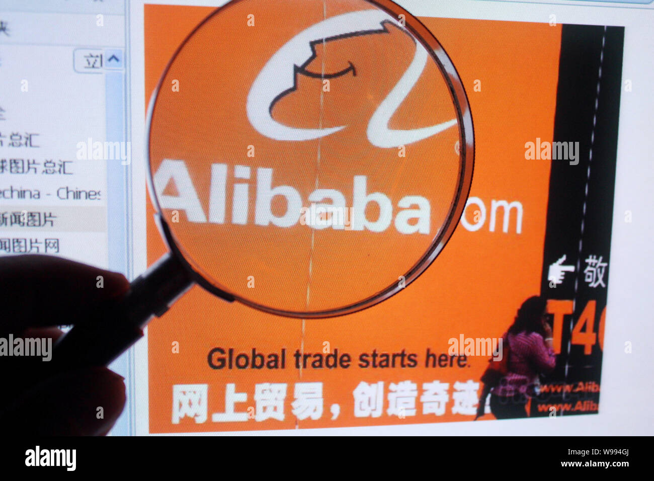 A Chinese Internet user browses an online photo of Alibaba.com in ...