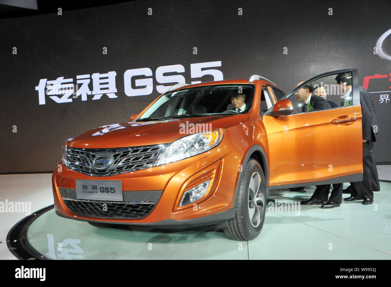 An official tries out a Trumpchi GS5 of GAC Group at a debut ceremony ...