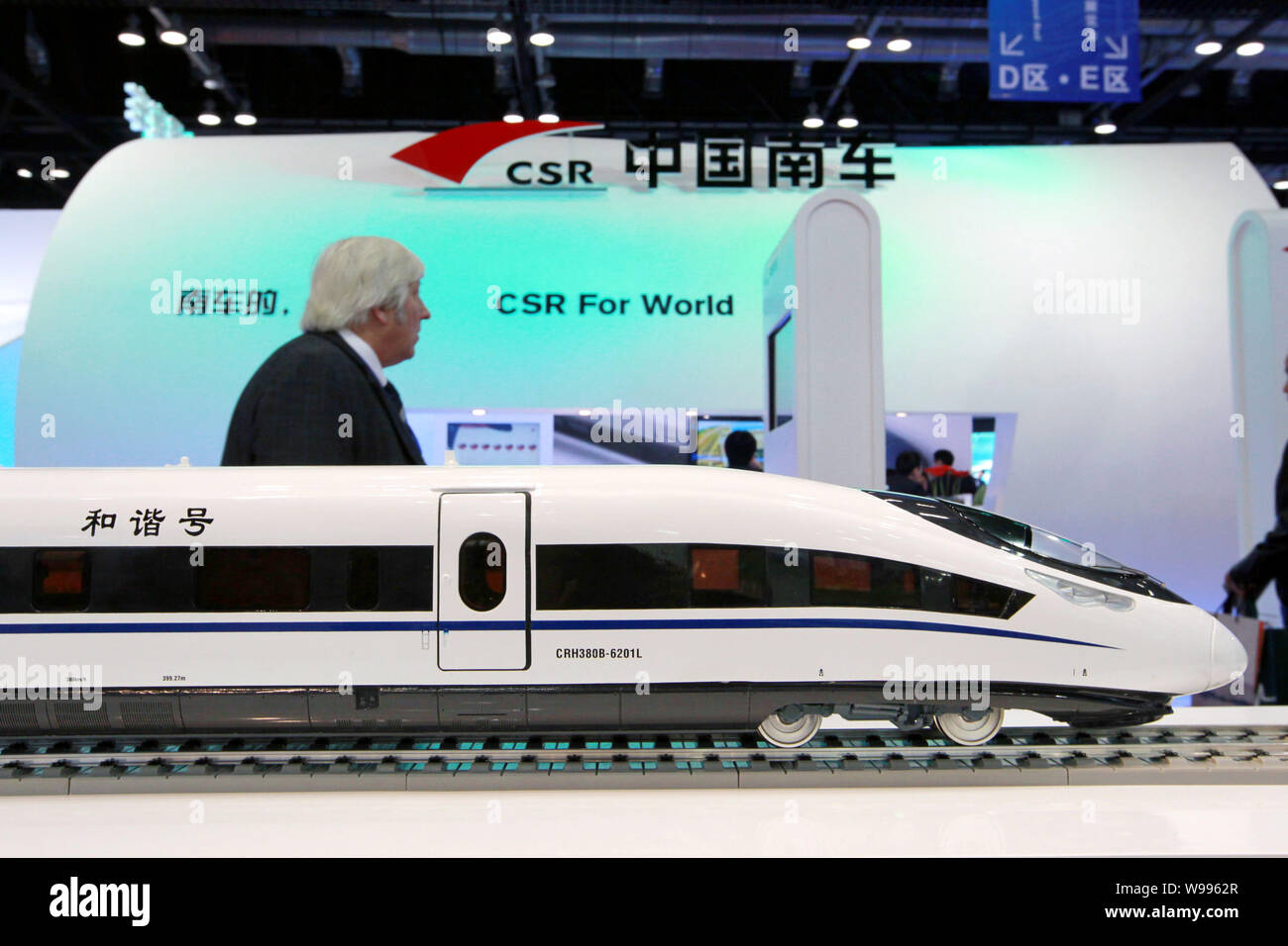 A visitor walks past a model of CRH380B high-speed train at the stand ...