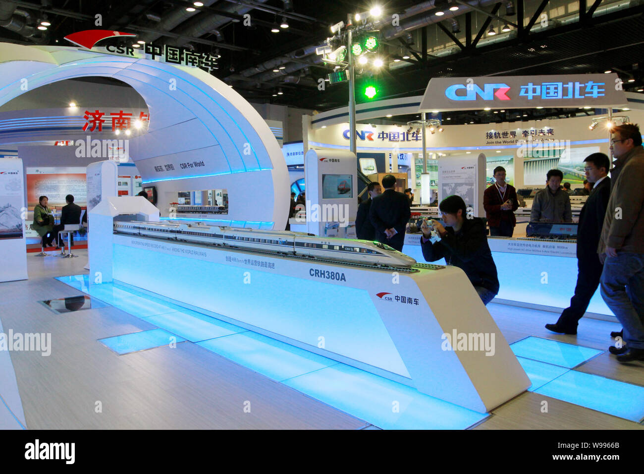 Visitors look at a model of CRH380A high-speed train at the stand of ...