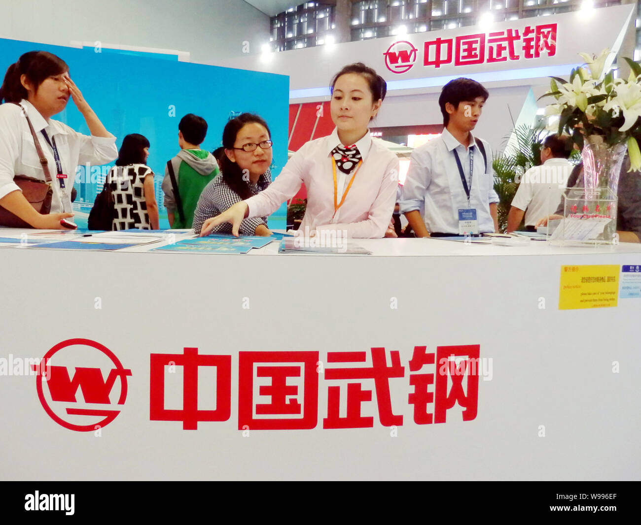 --FILE--Chinese employees and visitors are pictured at the stand of ...