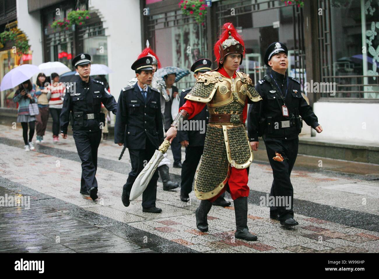 A policeman wearing a costume of ancient warrior patrols with his ...