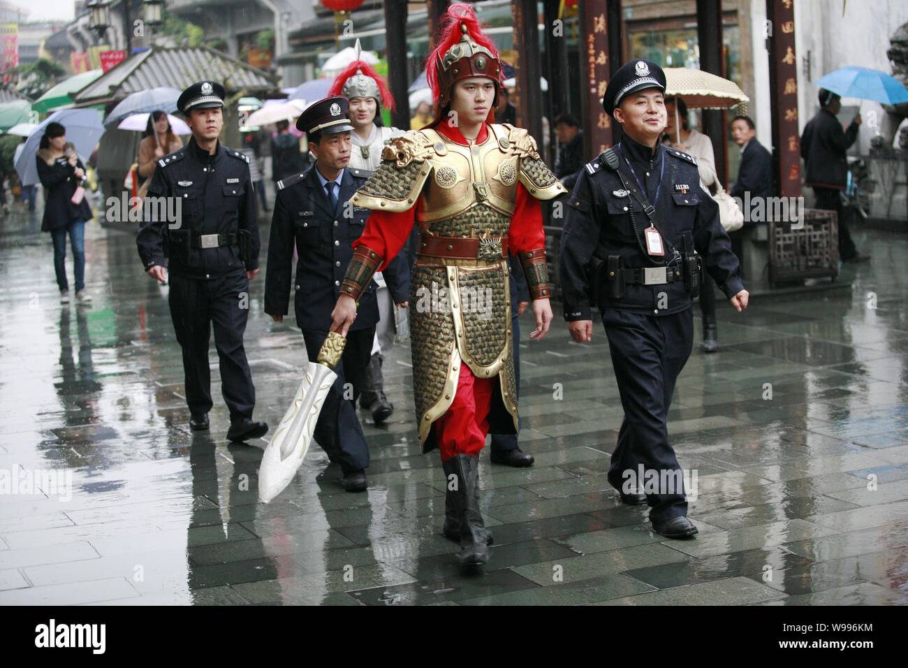 Policemen wearing costumes of ancient warrior patrol with his colleague ...