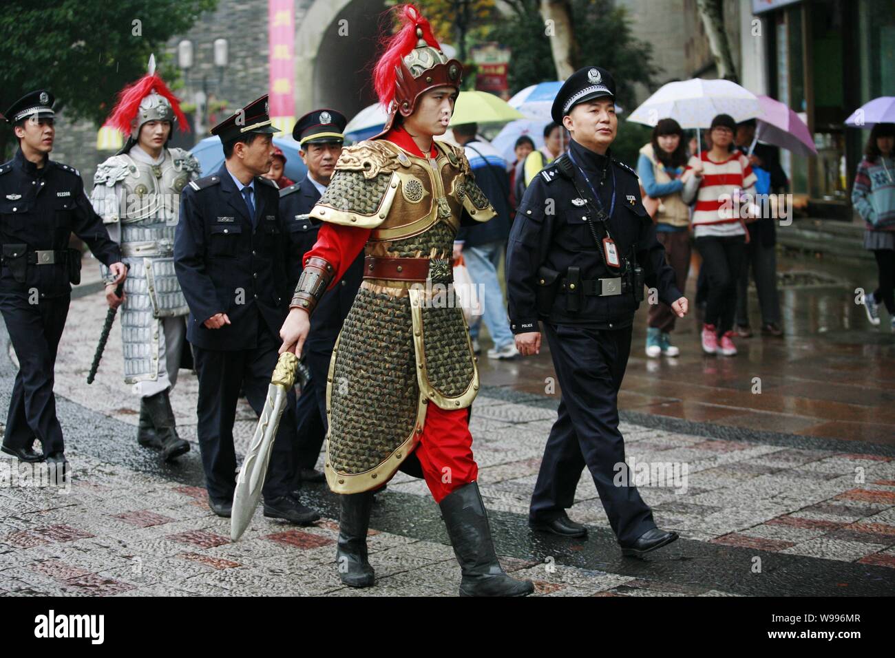 Policemen wearing costumes of ancient warrior patrol with his colleague ...
