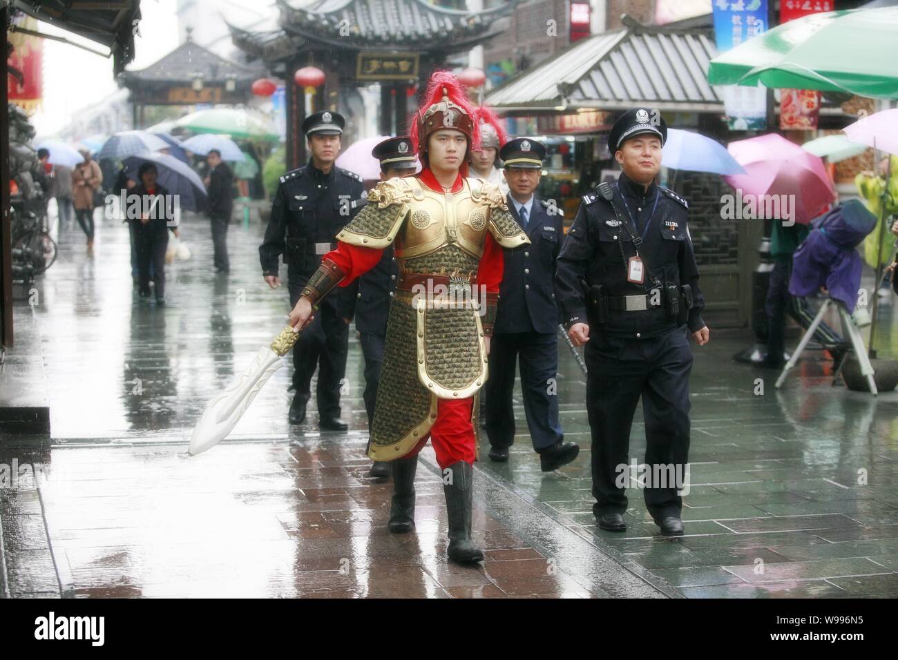 Policemen wearing costumes of ancient warrior patrol with his colleague ...