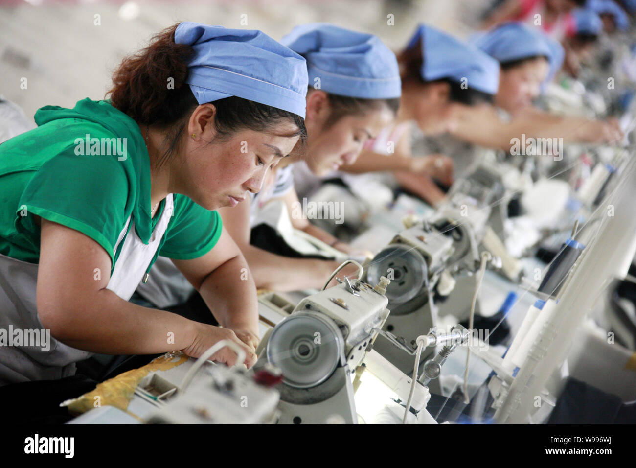 --FILE--Female Chinese workers sew clothes to be exported to southeast Asian countries at the ...