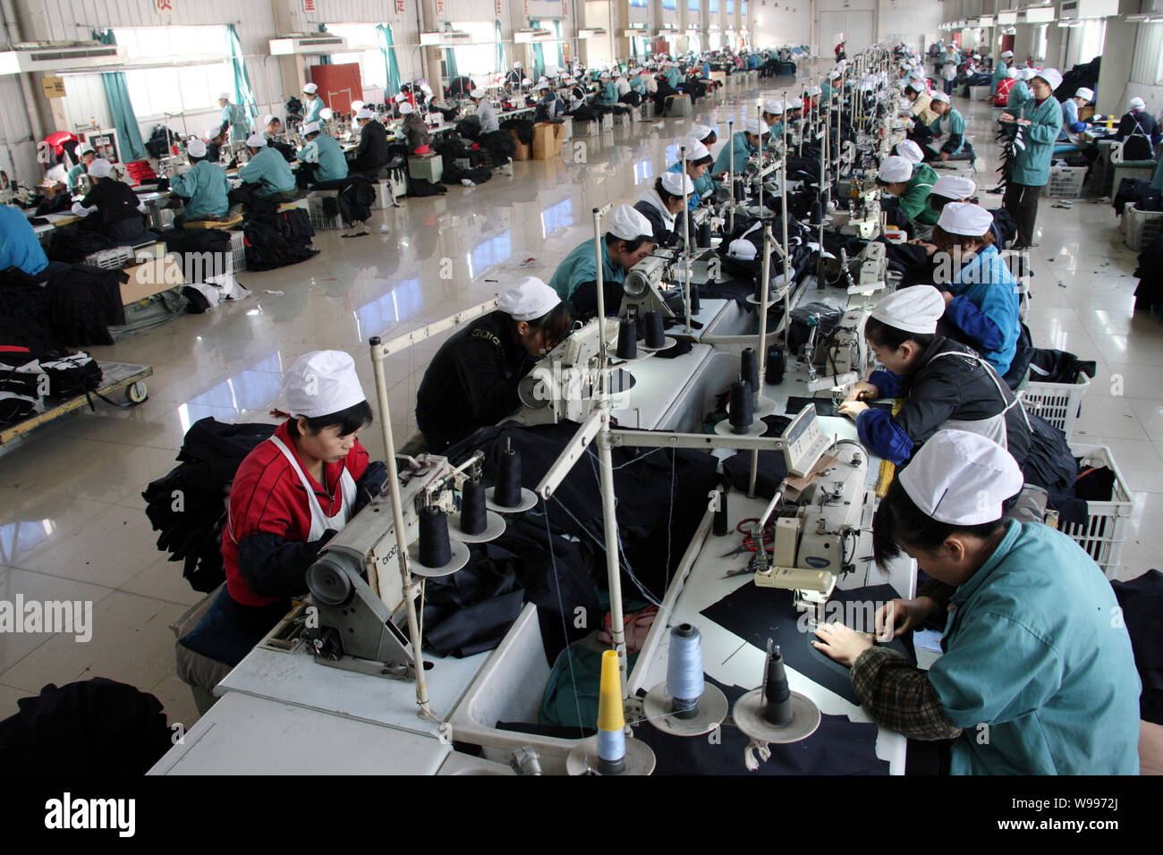 --File-- Female Chinese factory workers make clothes at a plant in ...