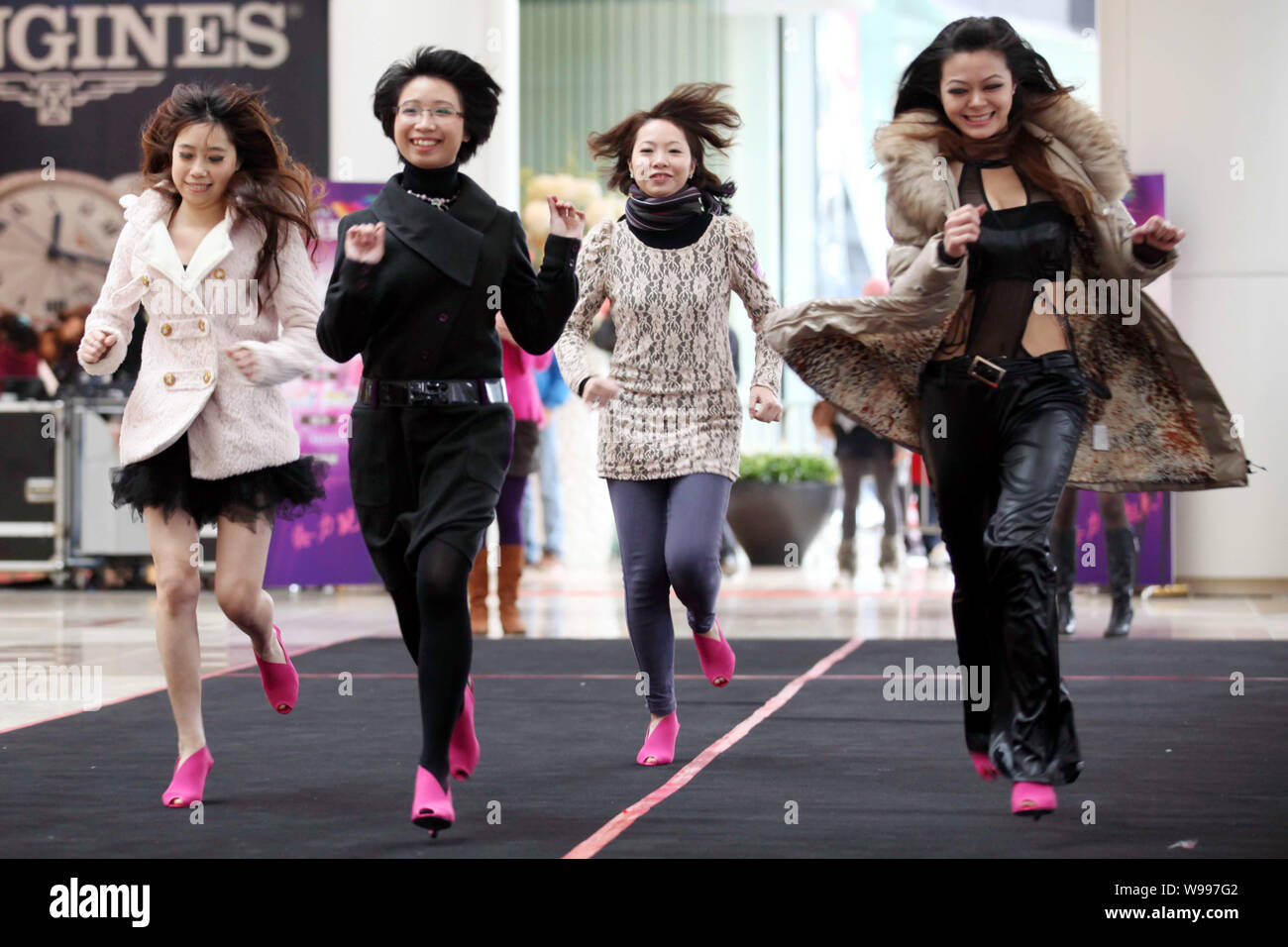 Young Chinese women wearing high-heel shoes compete in the shuttle run ...