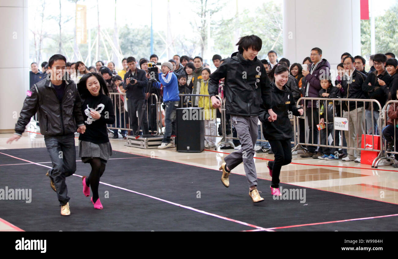 Young Chinese couples wearing high-heel shoes compete in the shuttle ...