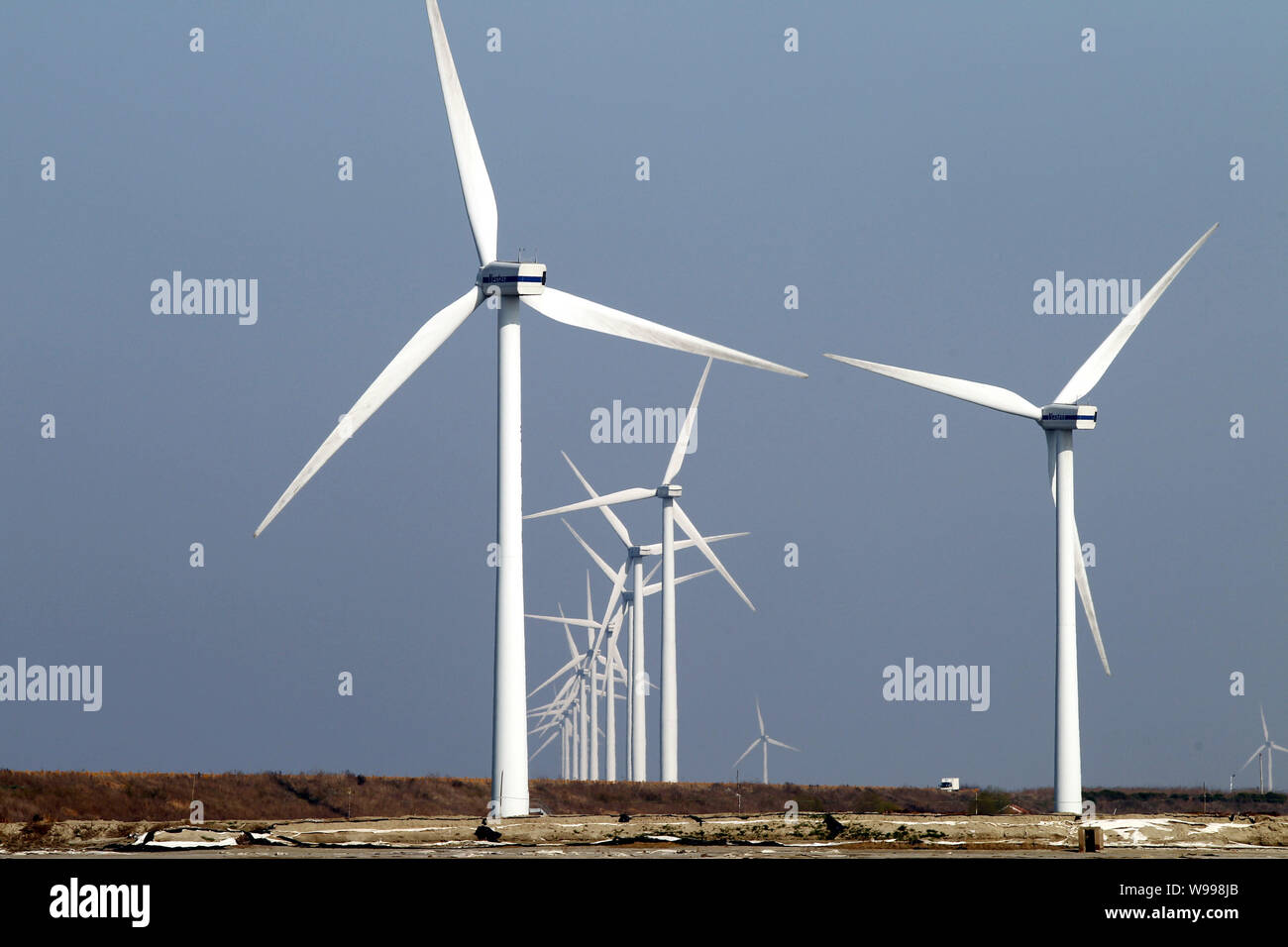 --FILE--Wind turbines whirl at a wind farm in Rudong county, Nantong ...