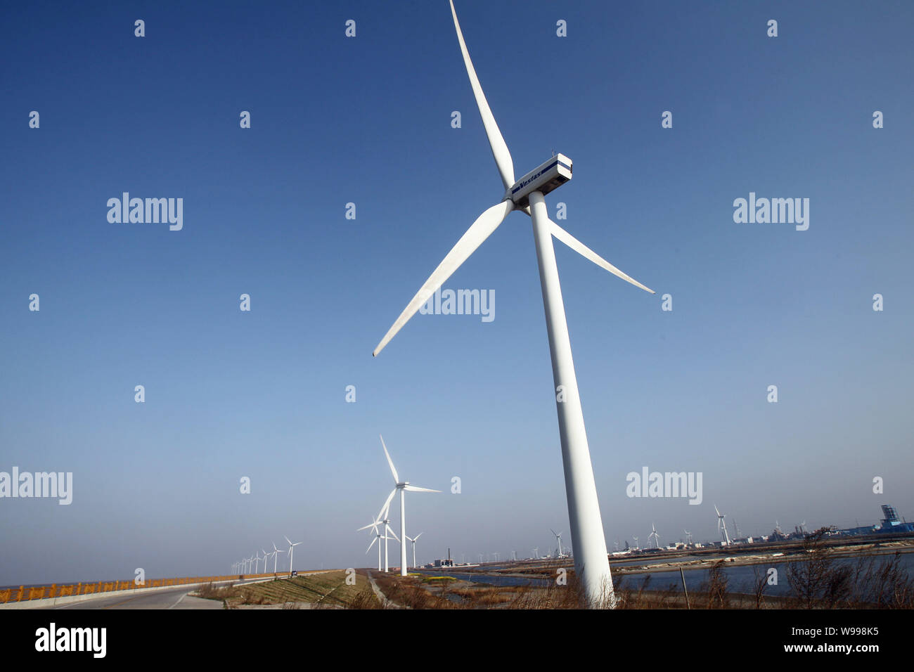 --FILE--Wind turbines whirl at a wind farm in Rudong county, Nantong ...