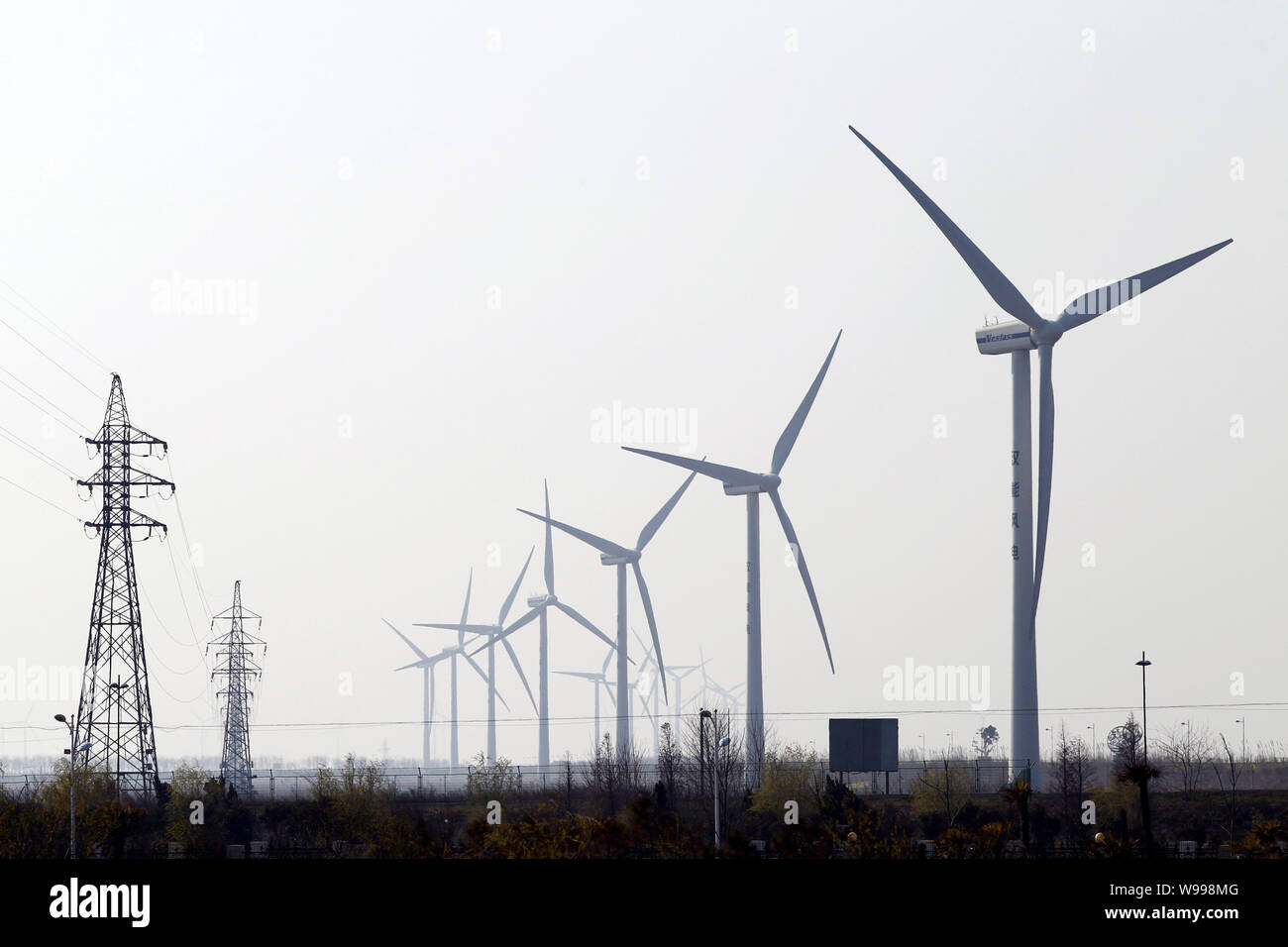 --FILE--Wind turbines whirl at a wind farm in Rudong county, Nantong ...