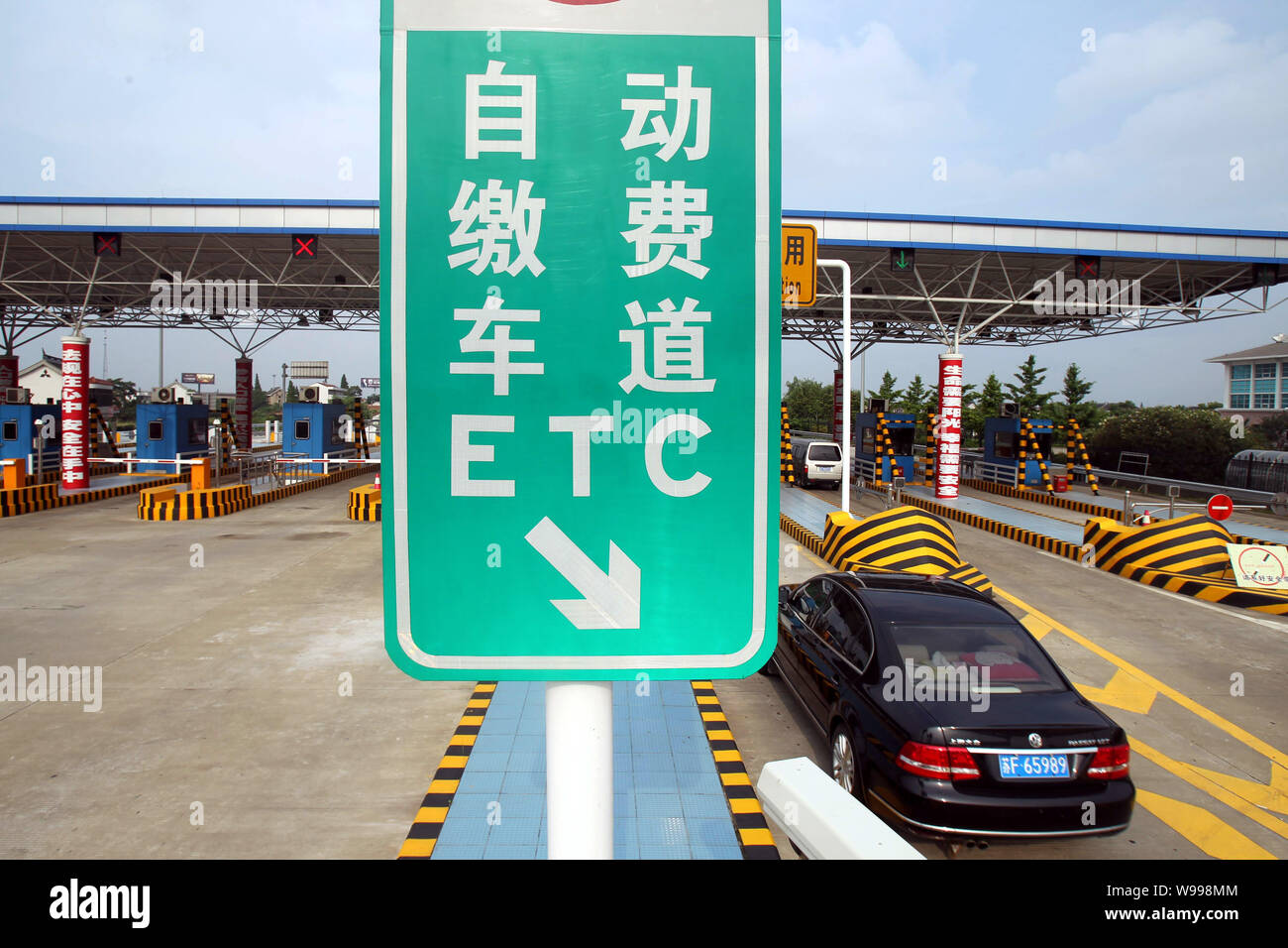 A car passes through the ETC (Electronic Toll Collection) lane at a ...