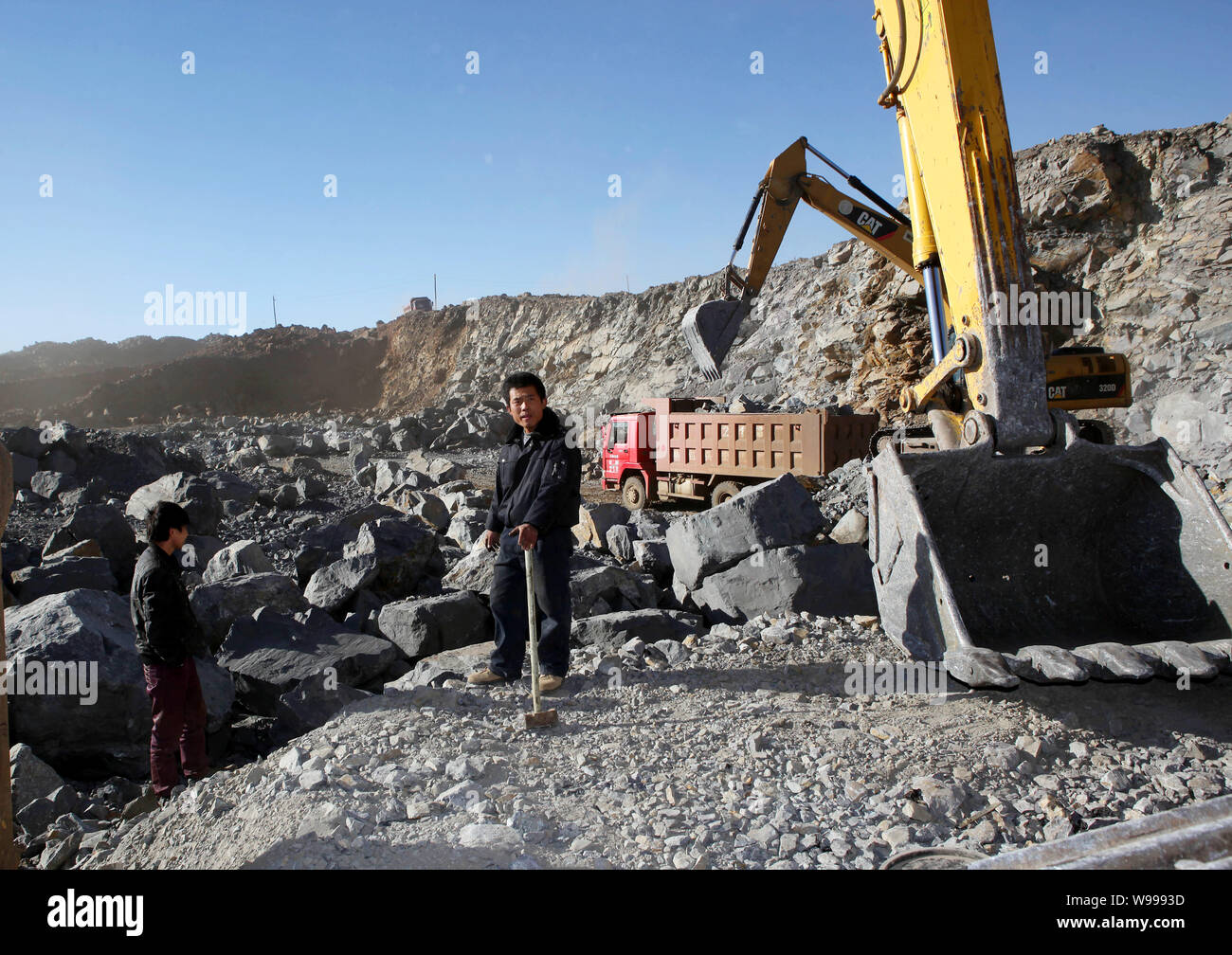 --FILE--Chinese workers labor at a rare earth mine in Baiyun Obo (or ...