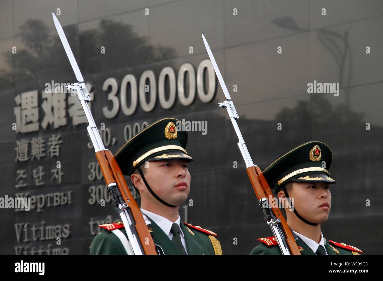 Chinese armed police carry guns during a ceremony marking the 74th ...