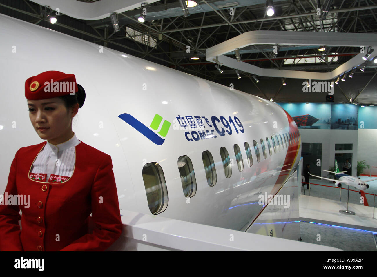--File--A Chinese attendant stands on a full scale model of the C919 ...