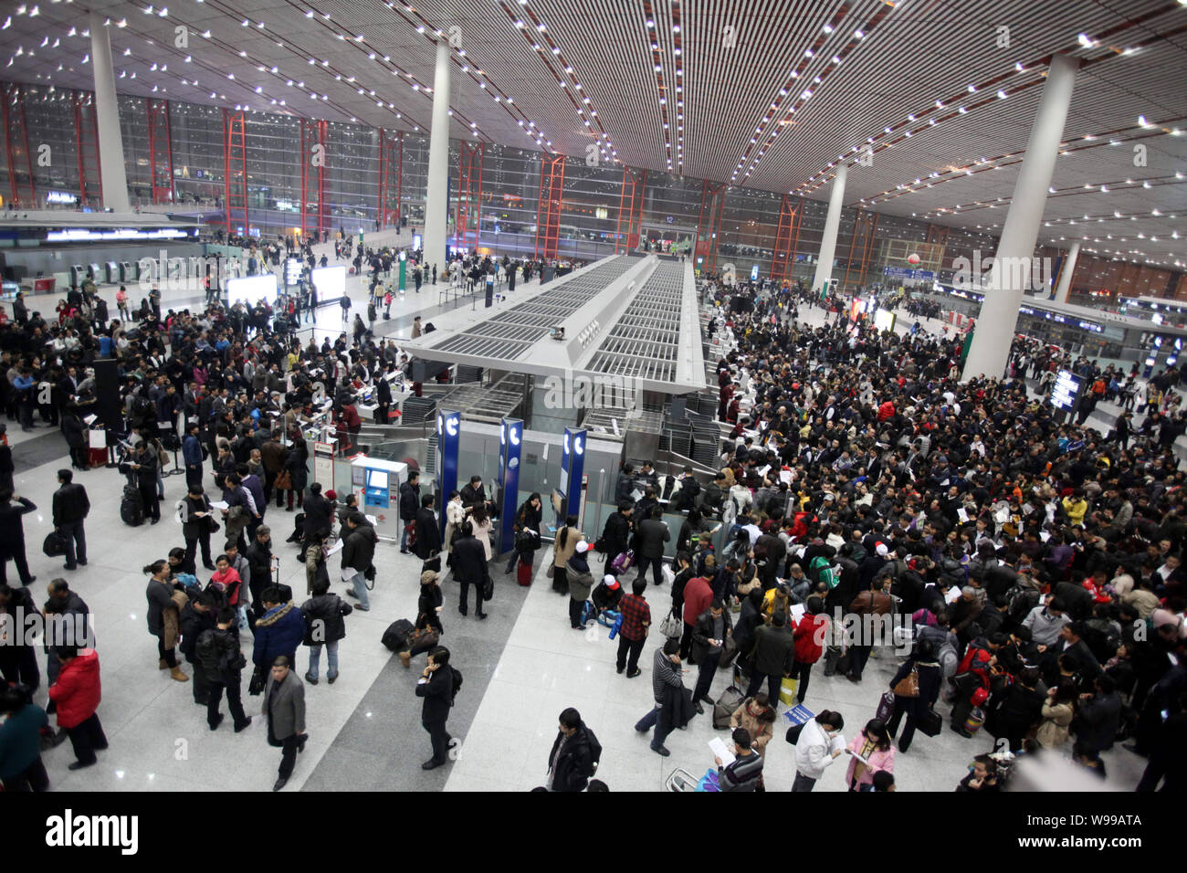 Passengers crowd the counters of airlines after their flights were ...