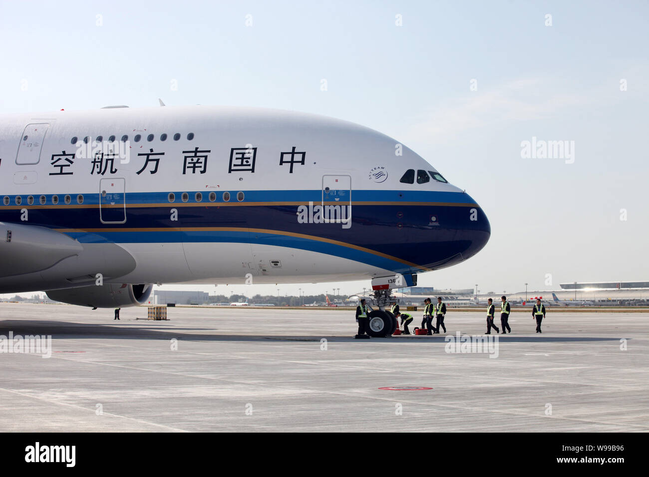 Chinese ground staff gather next to Chinas first Airbus A380 jumbo jet ...