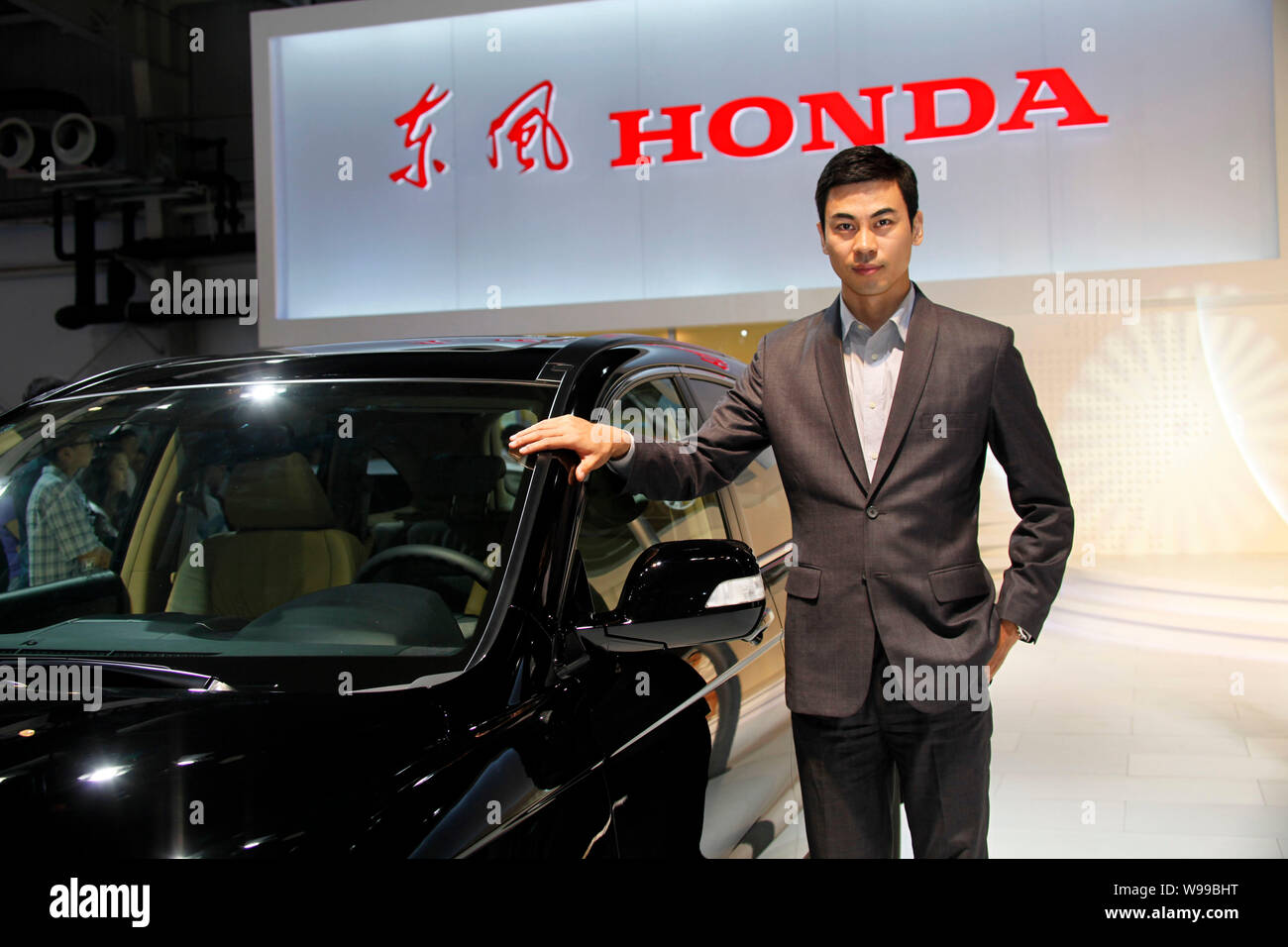 --File--A model poses with a Honda car at Changchun International Expo ...
