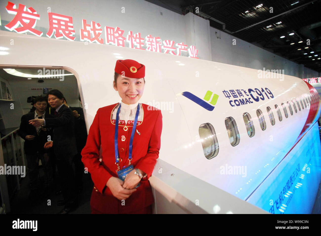 A Chinese Hostess Poses On A Full Scale Model Of The C919 Jet Plane Of Comac Commercial