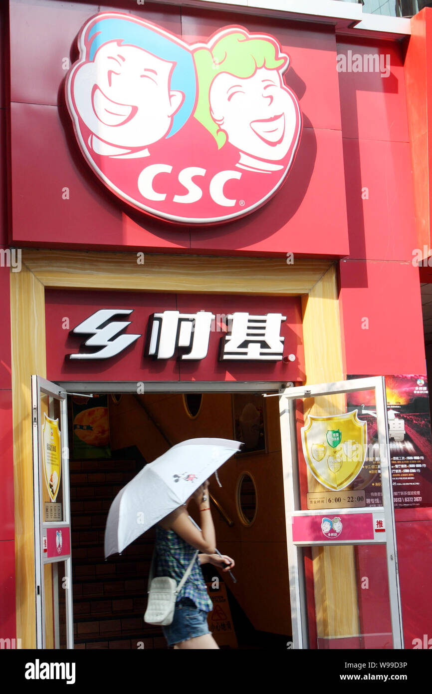 --FILE--A young woman walks past a CSC (Country Style Cooking) fast ...