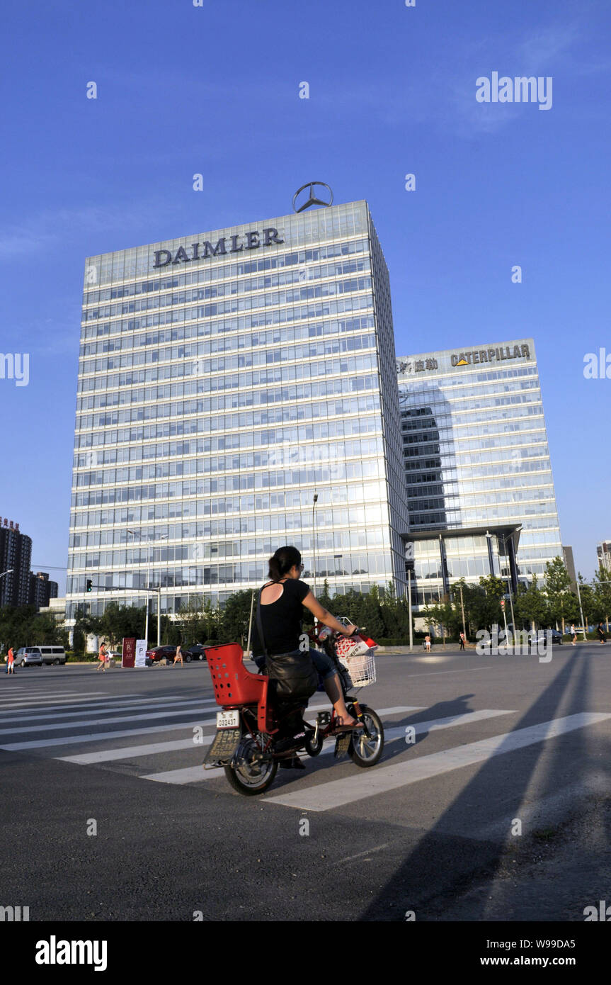 --FILE--A cyclist passes by the Daimler Tower where Mercedes-Benz ...