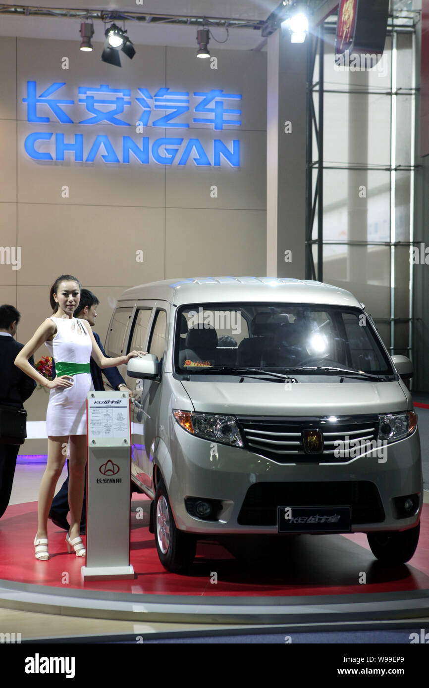 A model poses with a Changan car during an auto show in Guangzhou city ...