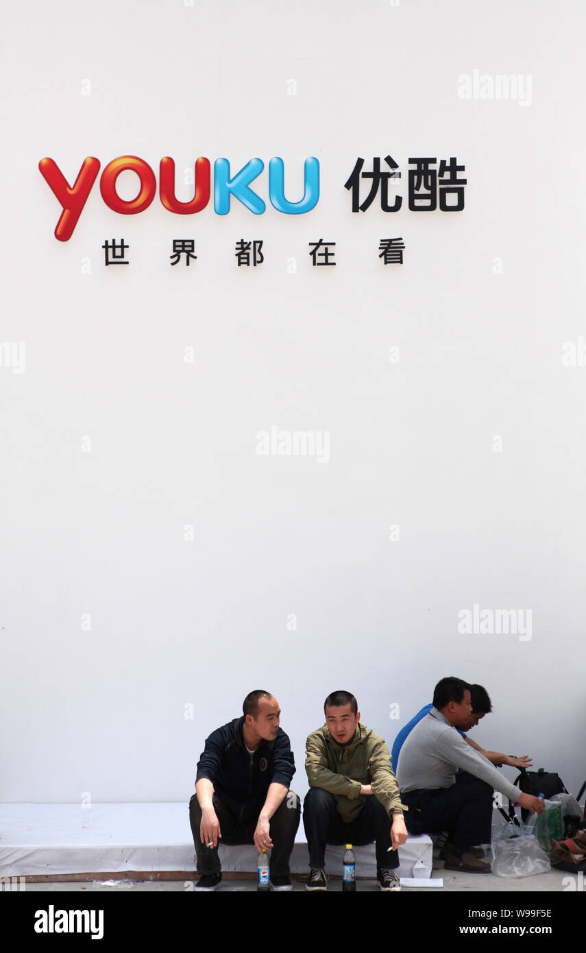--FILE--Visitors rest in front of an advertisement for online video ...